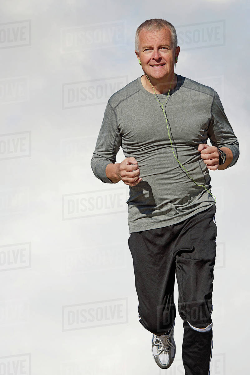 Man jogging outdoors - Stock Photo - Dissolve