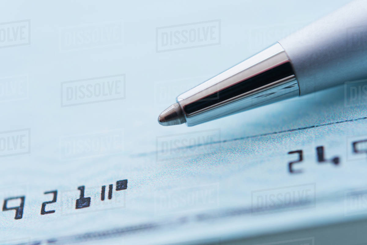 Detail of check with ballpoint pen, studio shot - Stock Photo - Dissolve