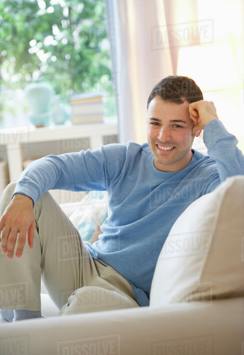 Man relaxing on sofa - Stock Photo - Dissolve