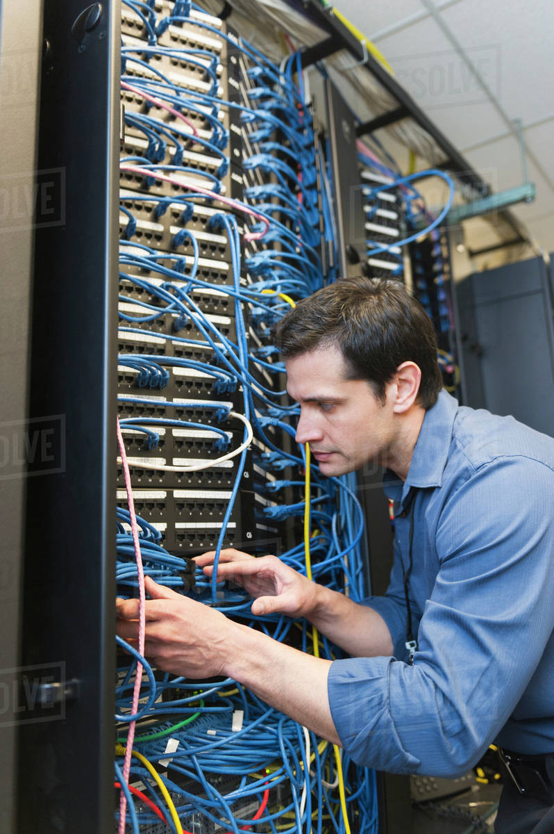 Technician inspecting network server - Royalty-free Stock Photo | Dissolve