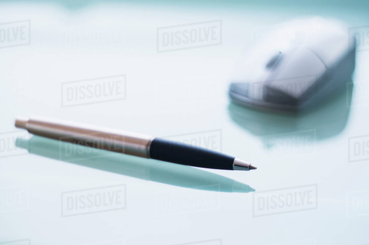 Pen and computer mouse - Stock Photo - Dissolve