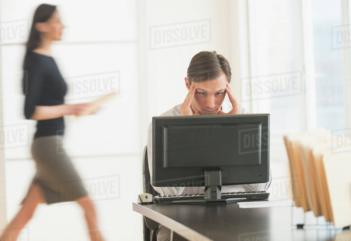 Office worker using computer - Stock Photo - Dissolve