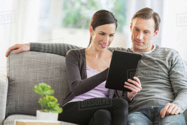 Couple using tablet pc - Royalty-free Stock Photo | Dissolve