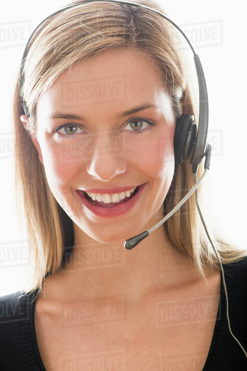 Studio portrait of young woman wearing headset - Royalty-free Stock ...