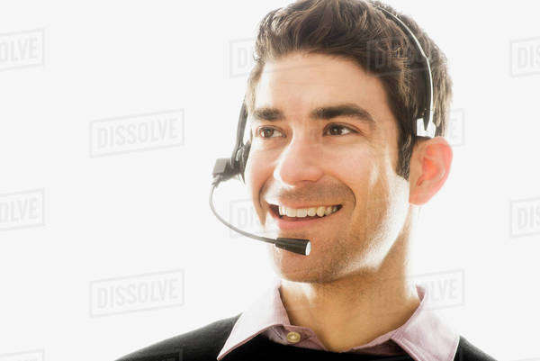 Studio portrait of man wearing headset - Stock Photo - Dissolve