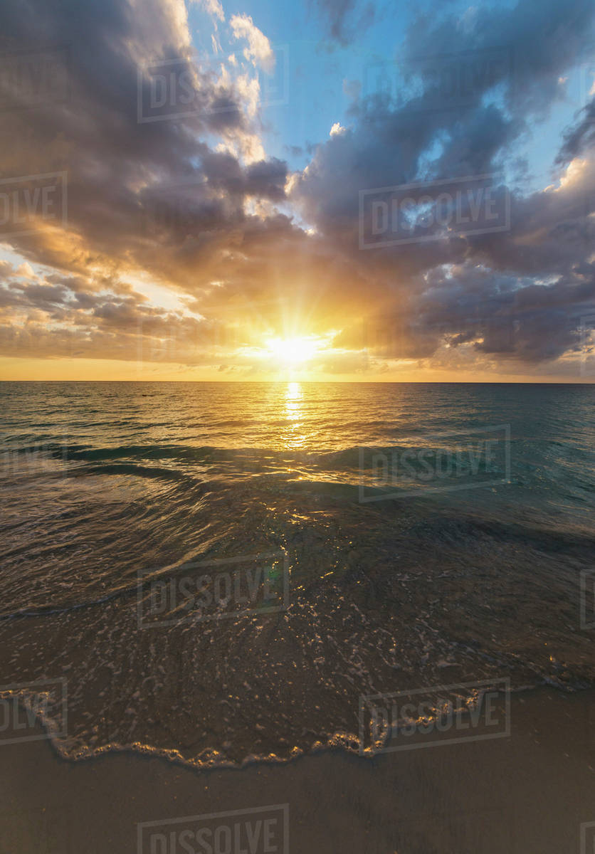 Sun setting over sea - Royalty-free Stock Photo | Dissolve