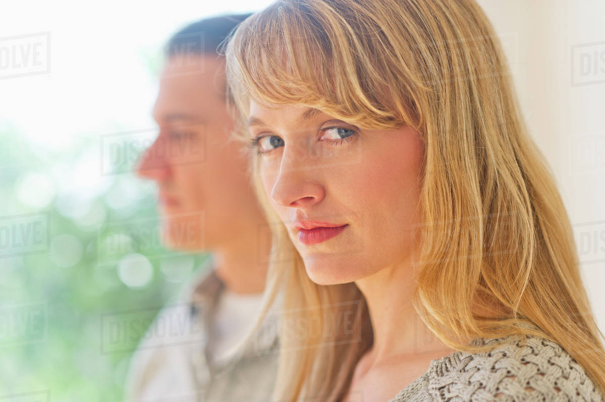 Close up woman's face with man in background - Royalty-free Stock Photo ...