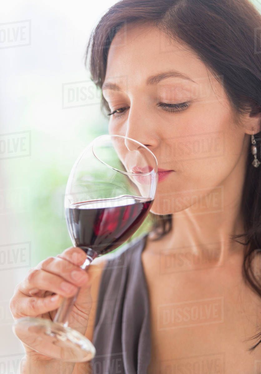 Woman tasting red wine - Royalty-free Stock Photo | Dissolve