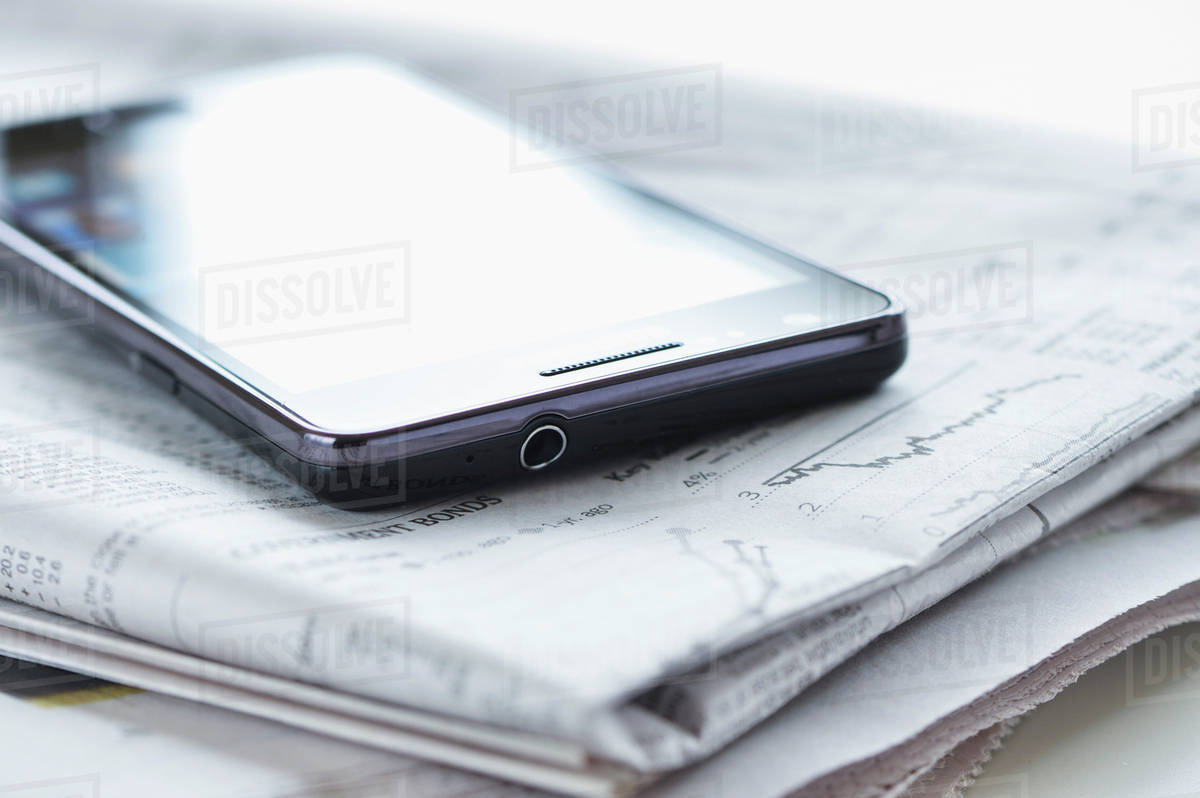Smartphone on newspaper - Royalty-free Stock Photo | Dissolve
