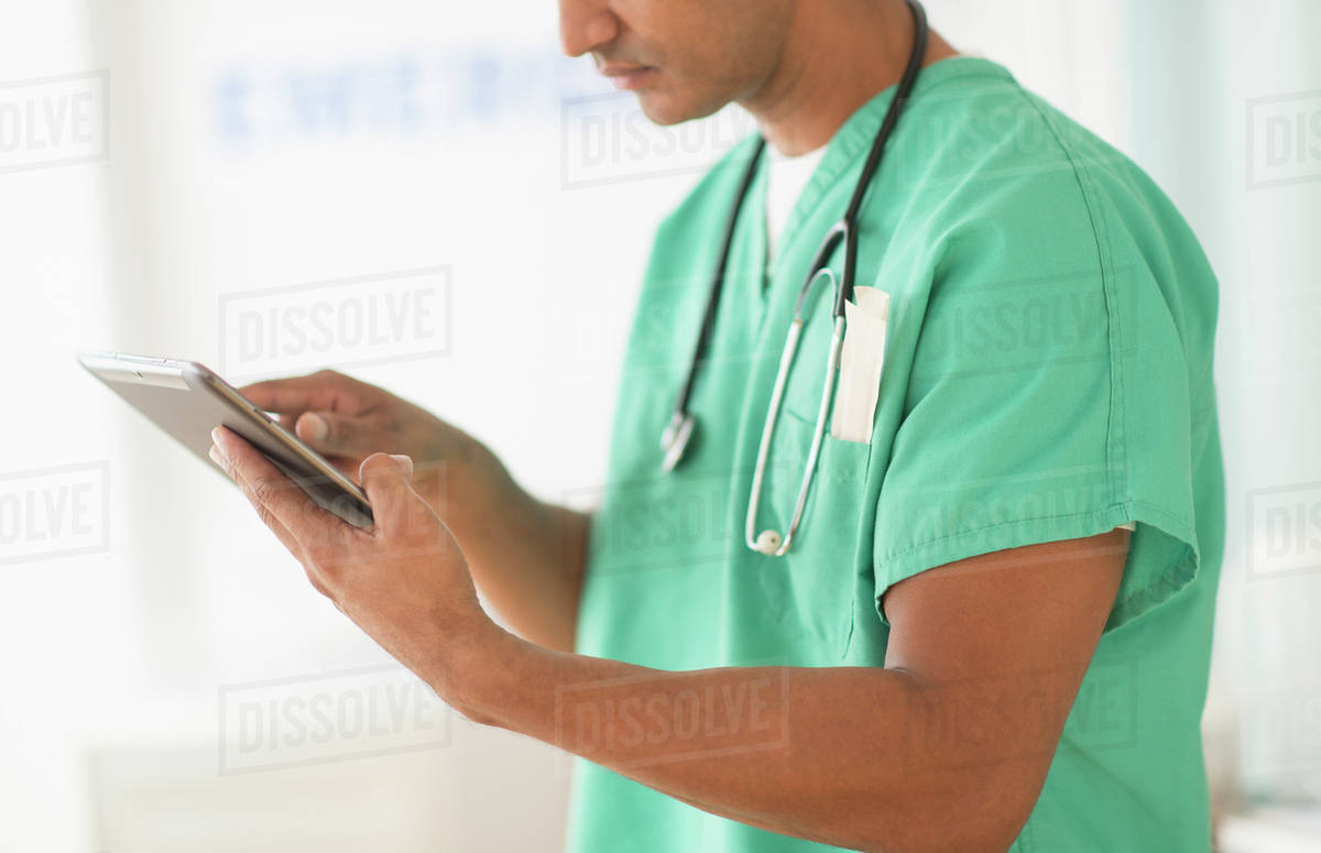Doctor using digital tablet - Stock Photo - Dissolve