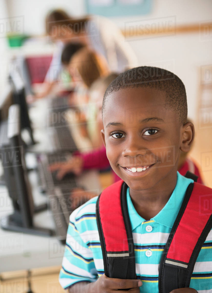 Portrait of smiling schoolboy (8-9) - Royalty-free Stock Photo | Dissolve