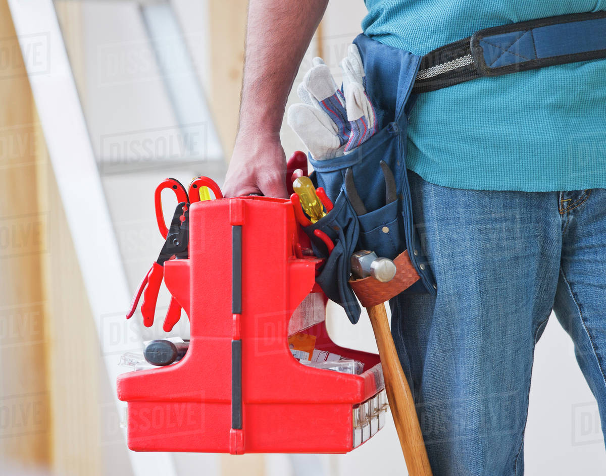 Close up of construction worker carrying tool box - Royalty-free Stock ...