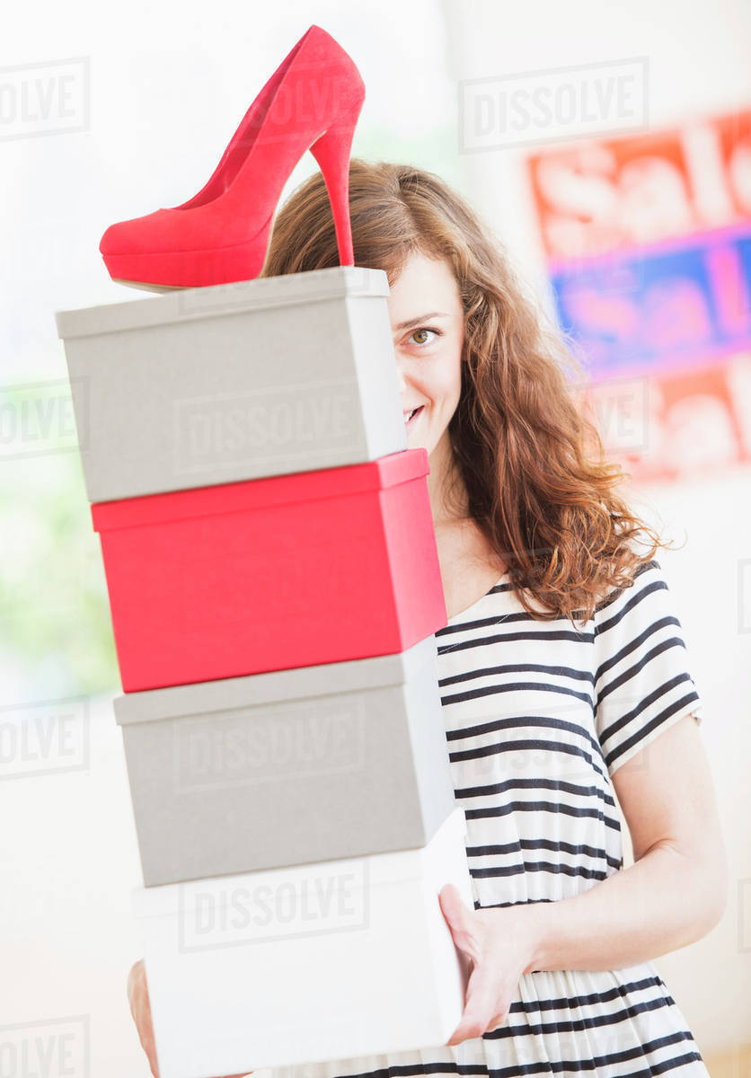Woman carrying shoes boxes - Royalty-free Stock Photo | Dissolve
