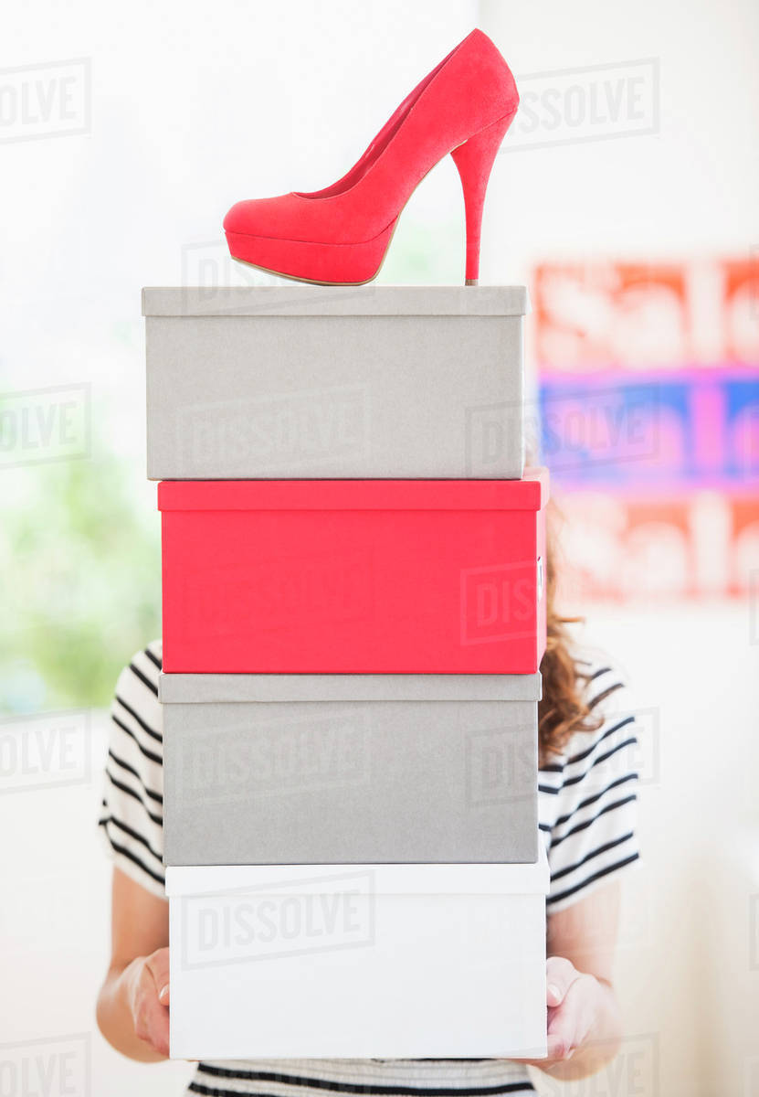Woman carrying shoes boxes - Royalty-free Stock Photo | Dissolve