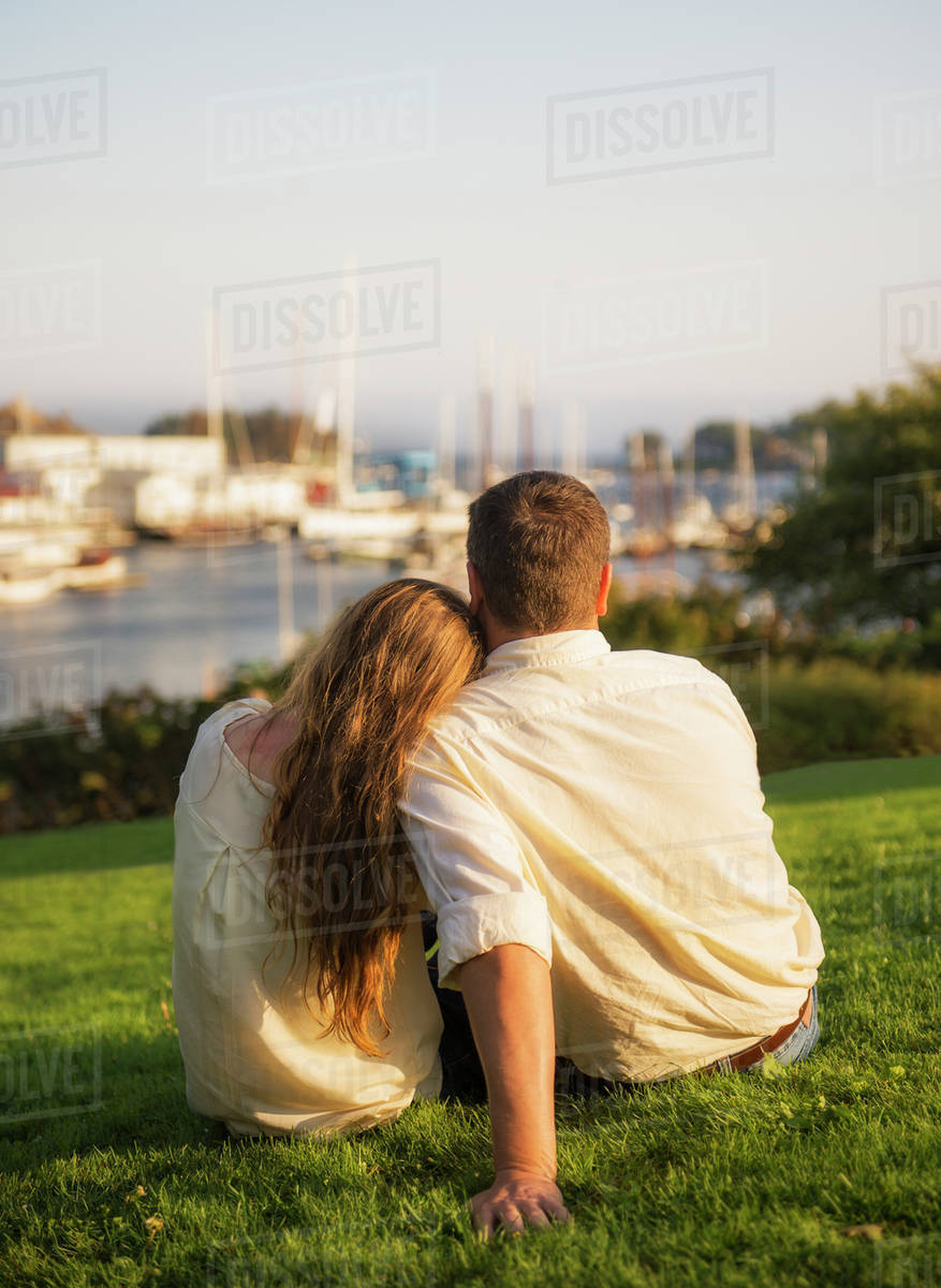 Back view of couple looking at harbor - Royalty-free Stock Photo | Dissolve