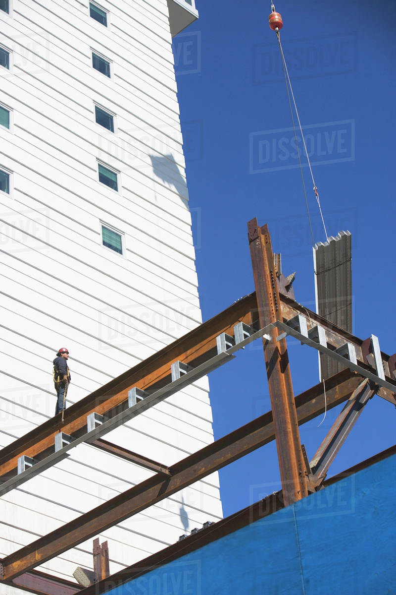 Construction worker on construction frame - Stock Photo - Dissolve