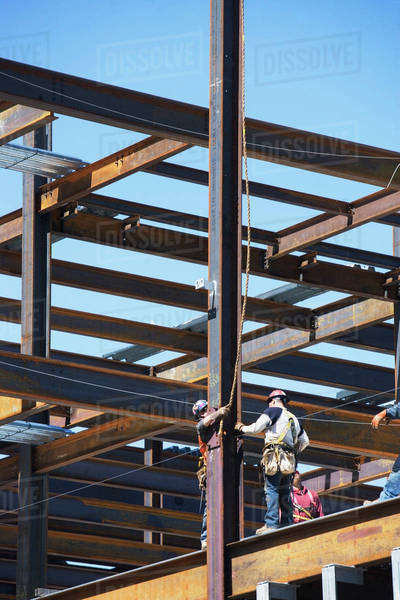Construction workers on construction frame - Stock Photo - Dissolve