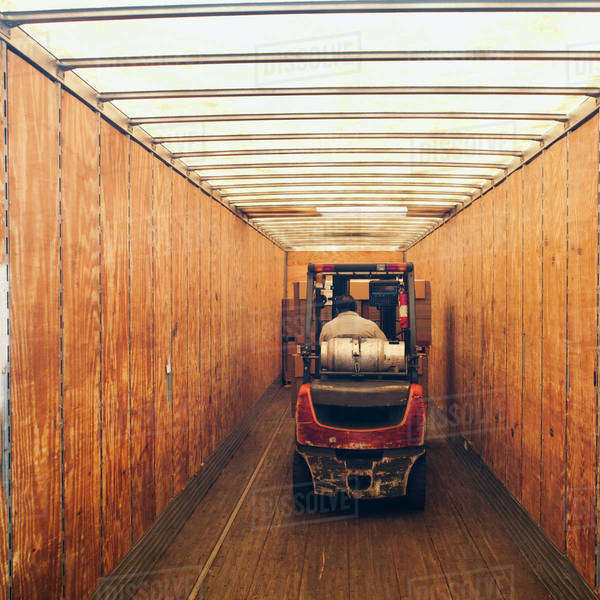 Forklift truck inside trailer - Royalty-free Stock Photo | Dissolve