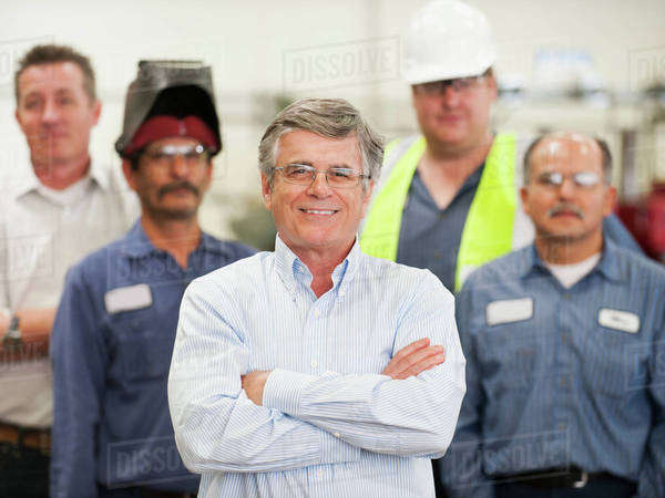 Portrait of businessman and workers in factory - Royalty-free Stock ...