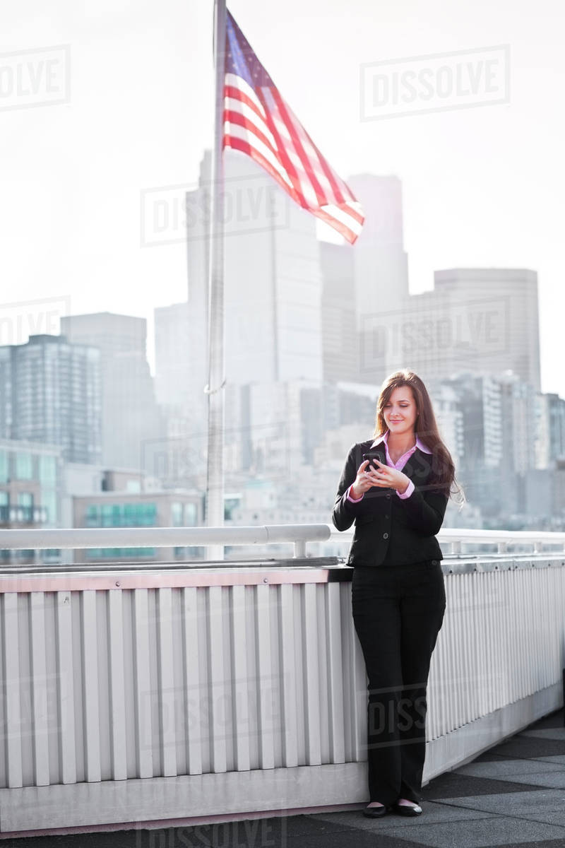 USA, Seattle, Smiling young businesswoman using mobile - Royalty-free ...