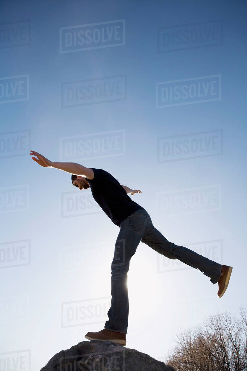Man balancing on rock - Royalty-free Stock Photo | Dissolve