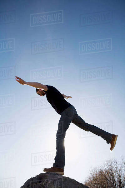 Man balancing on rock - Royalty-free Stock Photo | Dissolve