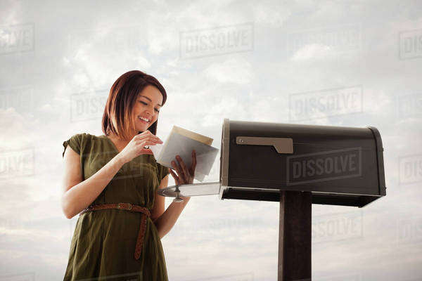 Young woman at mailbox - Royalty-free Stock Photo | Dissolve