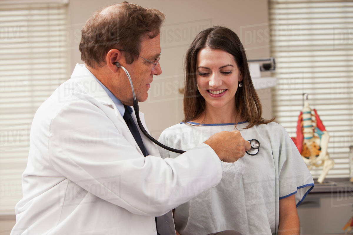 Doctor checking patients heart rate with Stethoscope - Stock Photo ...