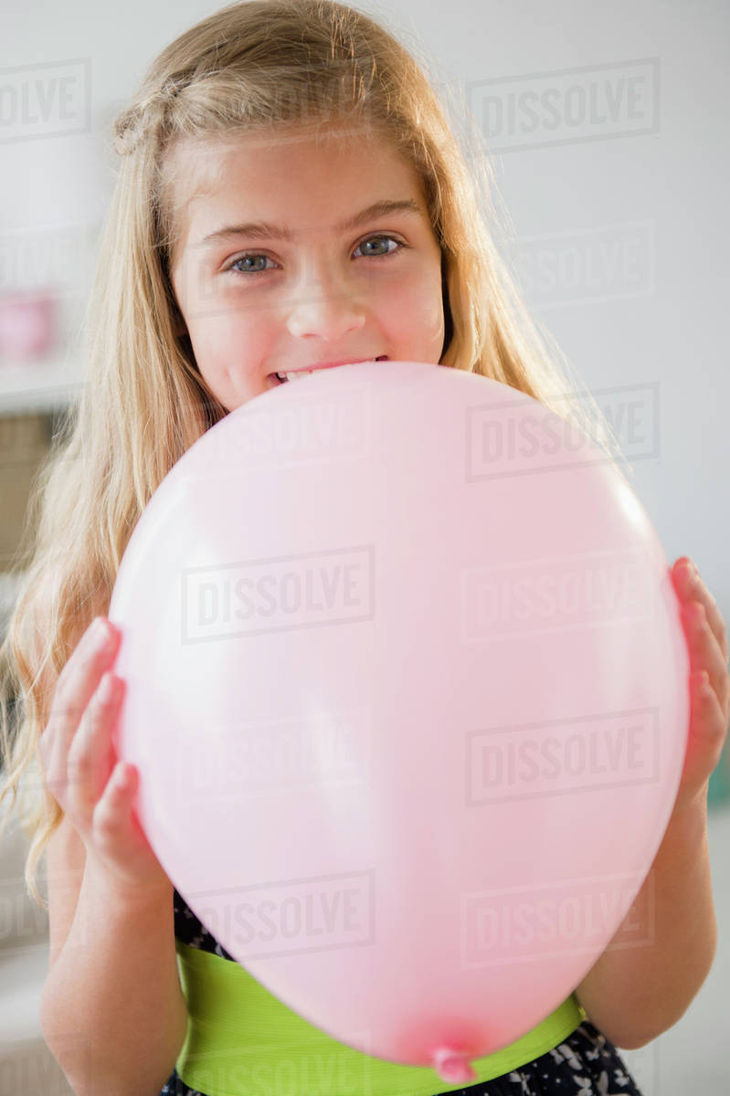 Girl (8-9) with pink balloon - Royalty-free Stock Photo | Dissolve