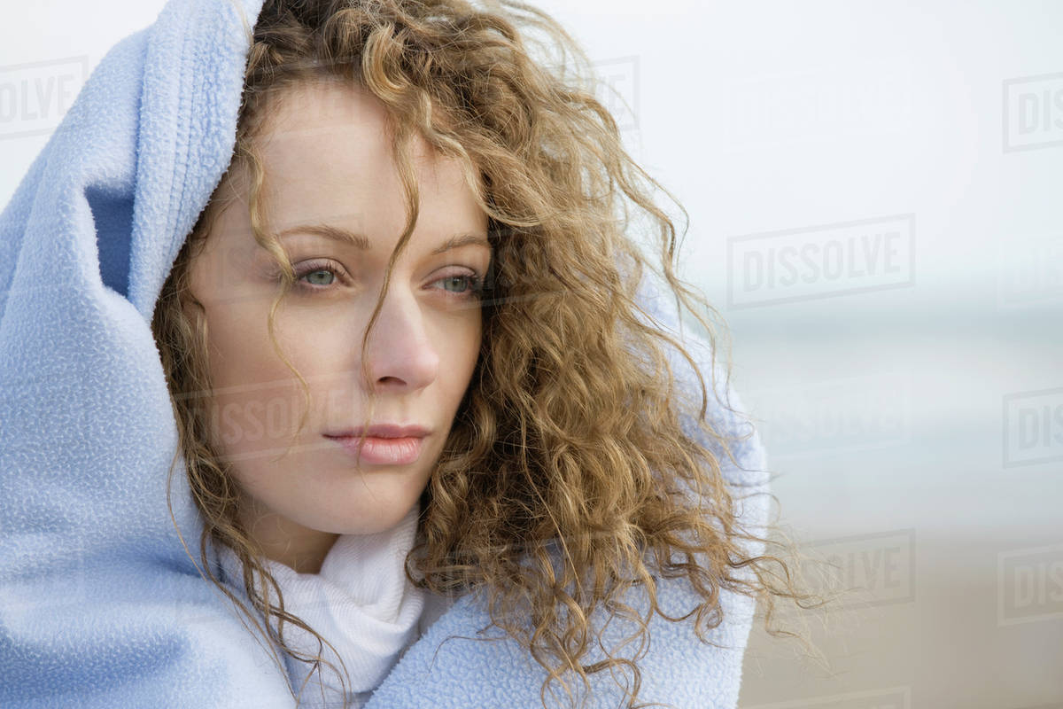 Portrait of young woman wrapped in blanket - Royalty-free Stock Photo ...