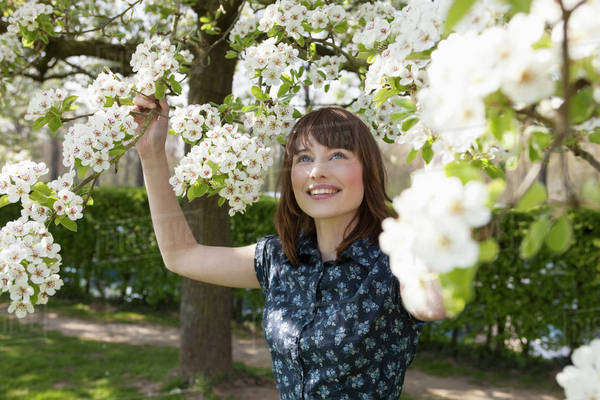 Portrait of young woman in spring orchard - Royalty-free Stock Photo ...