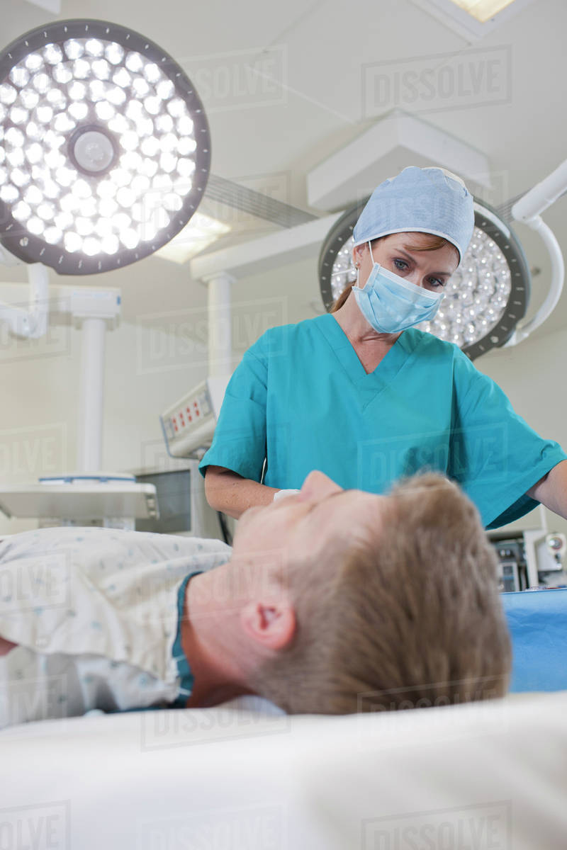 Surgeon preparing patient for surgery - Royalty-free Stock Photo | Dissolve