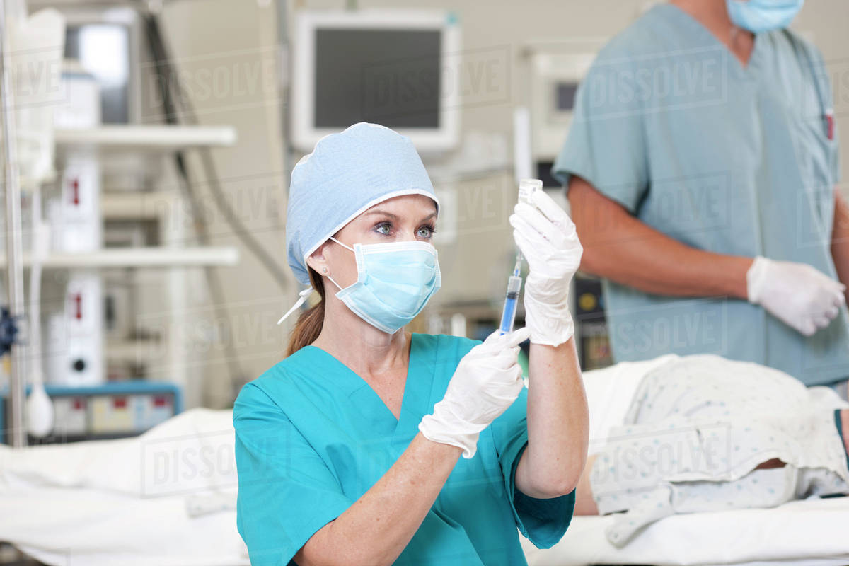 Surgeons preparing patient for surgery - Royalty-free Stock Photo ...