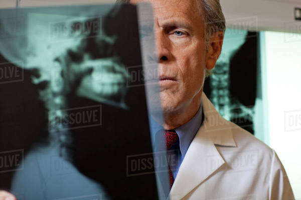 Doctor looking at x-ray - Royalty-free Stock Photo | Dissolve