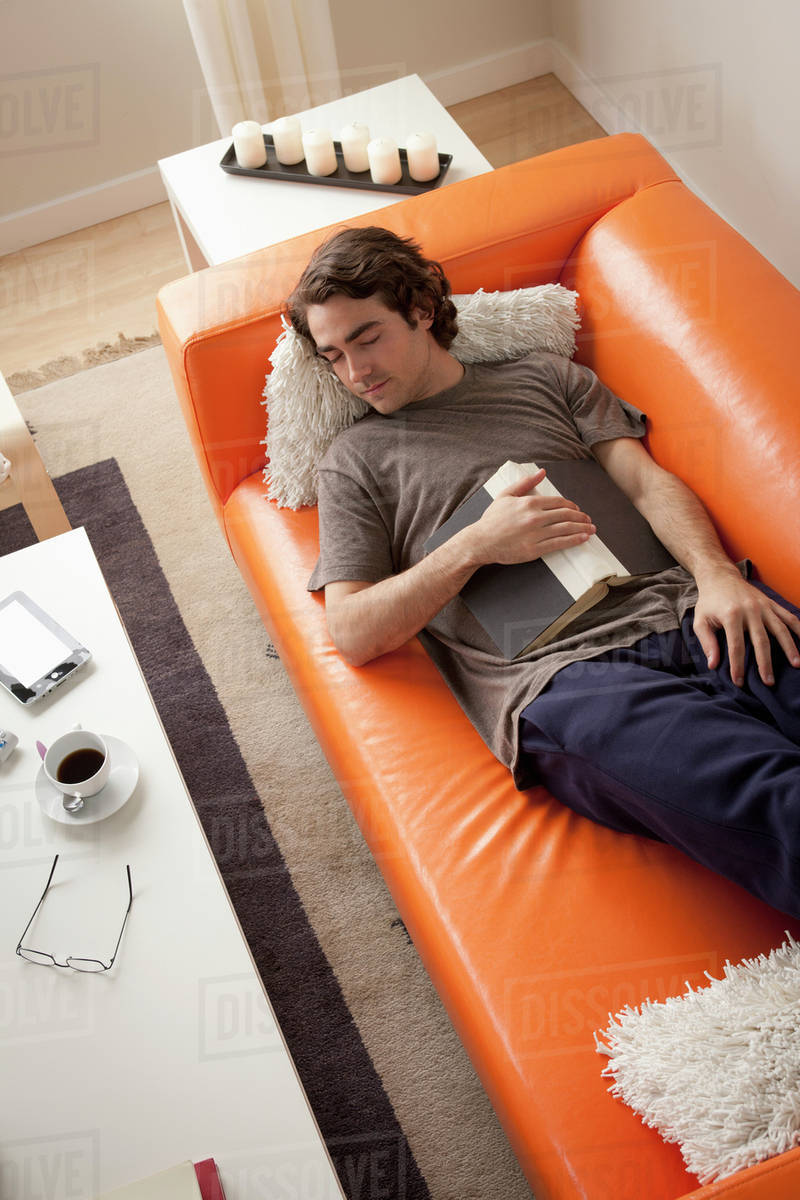 Young man sleeping on sofa - Royalty-free Stock Photo | Dissolve