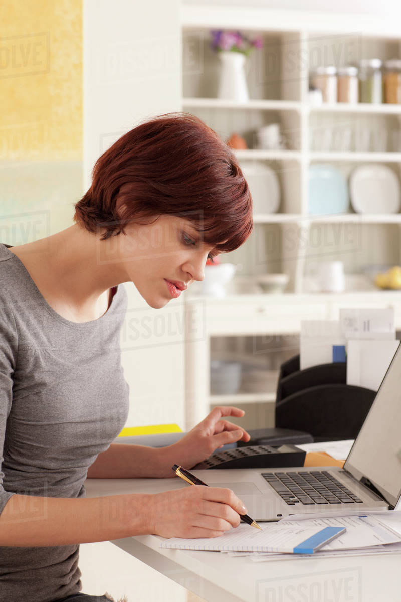 Young woman working at home - Royalty-free Stock Photo | Dissolve