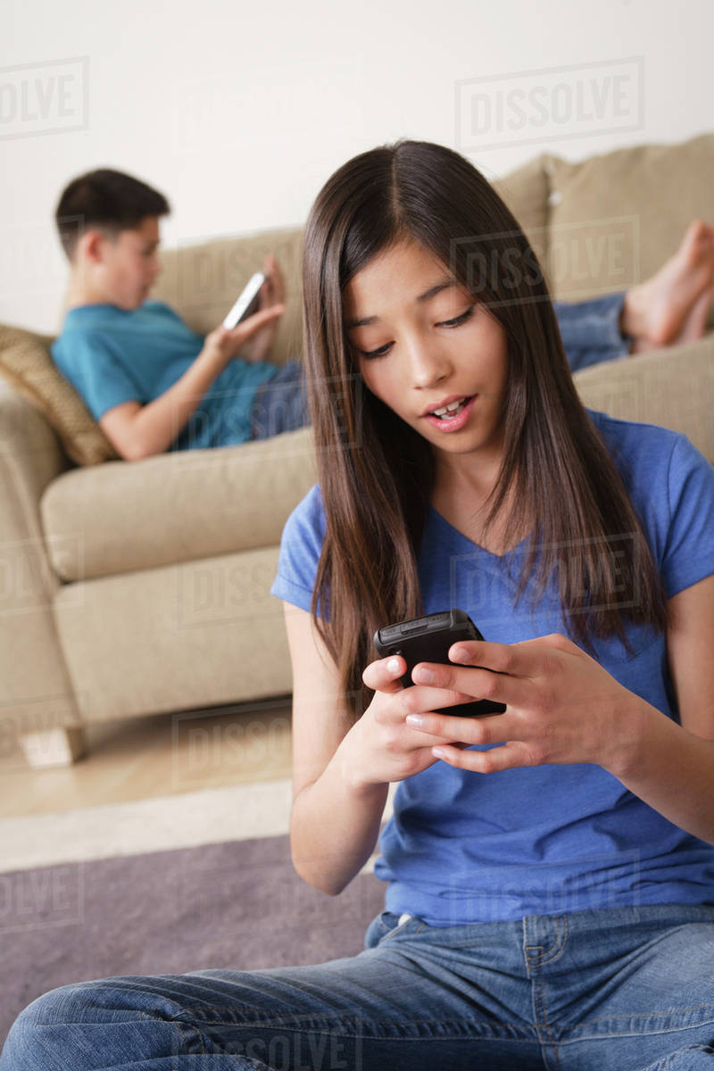 Girl using smartphone - Royalty-free Stock Photo | Dissolve