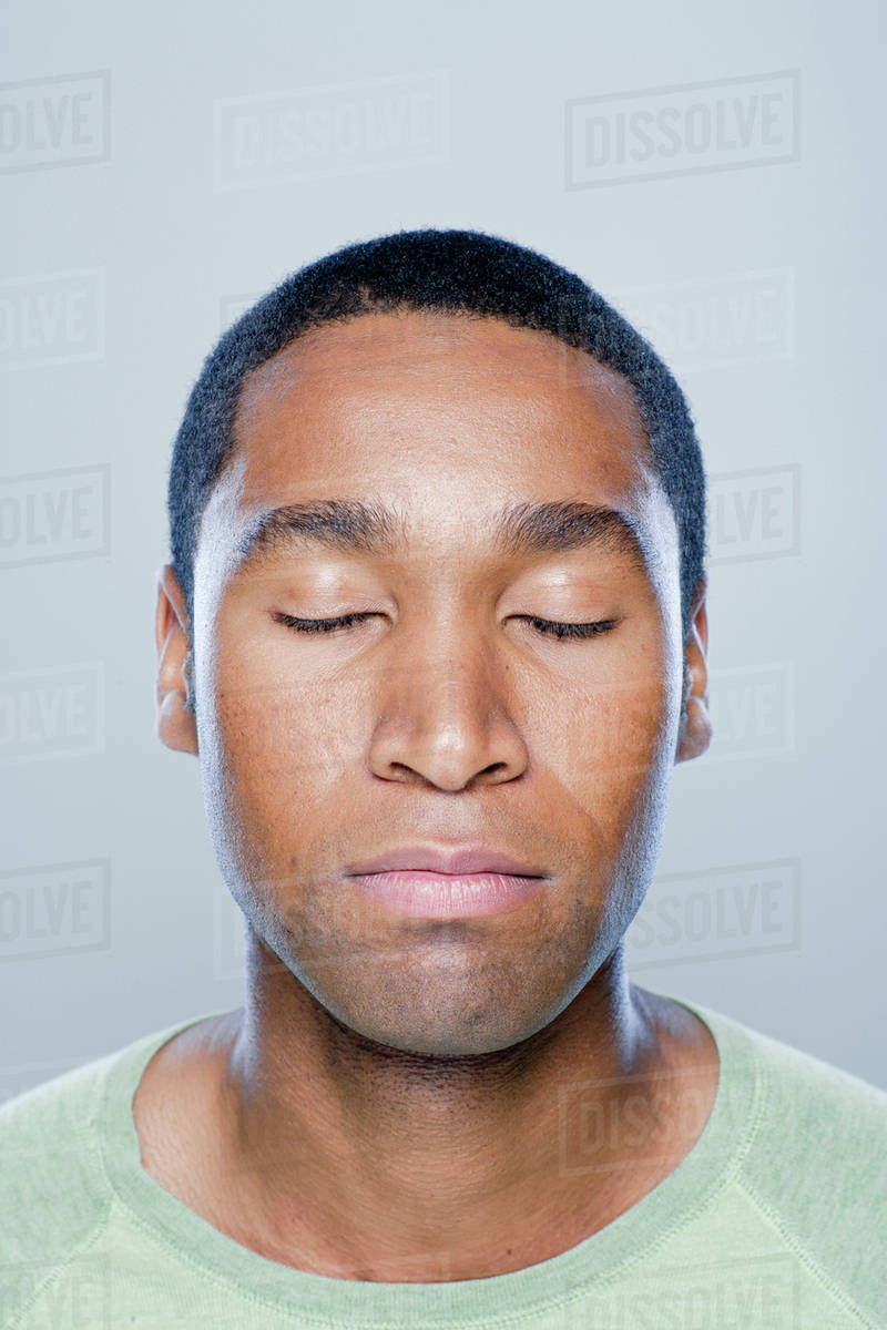 Portrait of young man with eyes closed, studio shot - Royalty-free ...