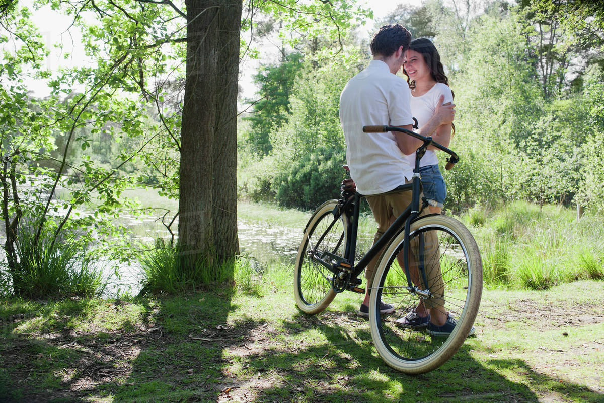 Couple kissing near bike - Royalty-free Stock Photo | Dissolve