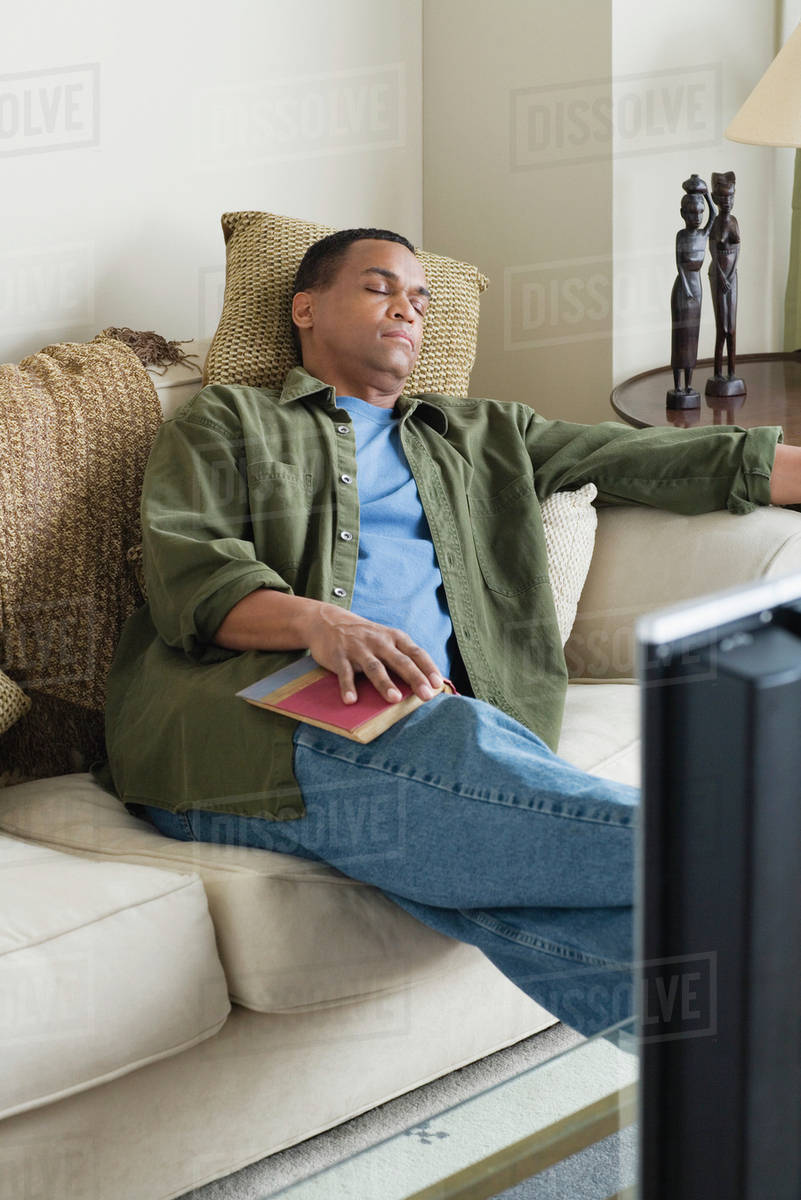 Man napping on sofa - Royalty-free Stock Photo | Dissolve