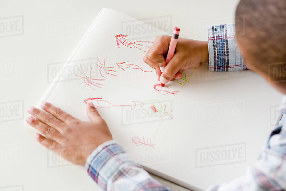 Boy (6-7) drawing in classroom - Royalty-free Stock Photo | Dissolve