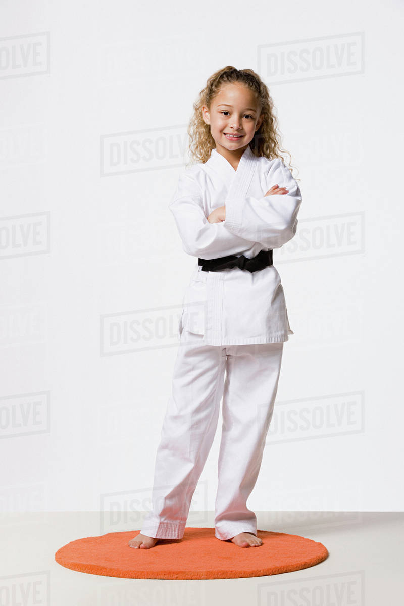 Girl (8-9) wearing gi, studio shot - Royalty-free Stock Photo | Dissolve