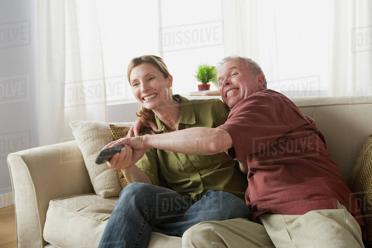 Couple fighting for tv remote - Royalty-free Stock Photo | Dissolve