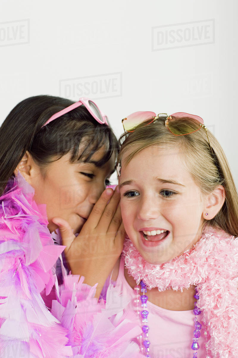 Two girls (10-11) gossiping - Royalty-free Stock Photo | Dissolve