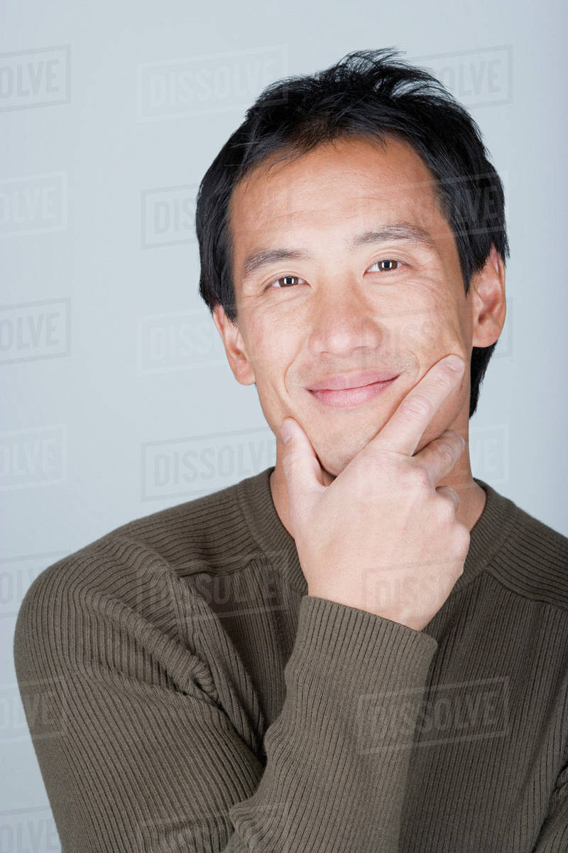 Studio portrait of happy Asian man - Royalty-free Stock Photo | Dissolve