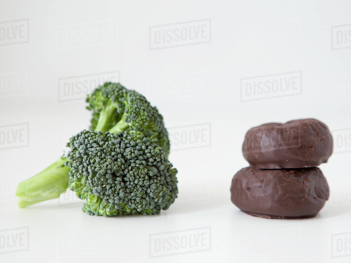 Broccoli and chocolate cookies on white background, studio shot - Stock ...