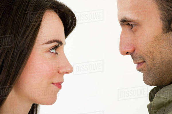 Studio profile of couple looking in eyes face to face - Royalty-free ...