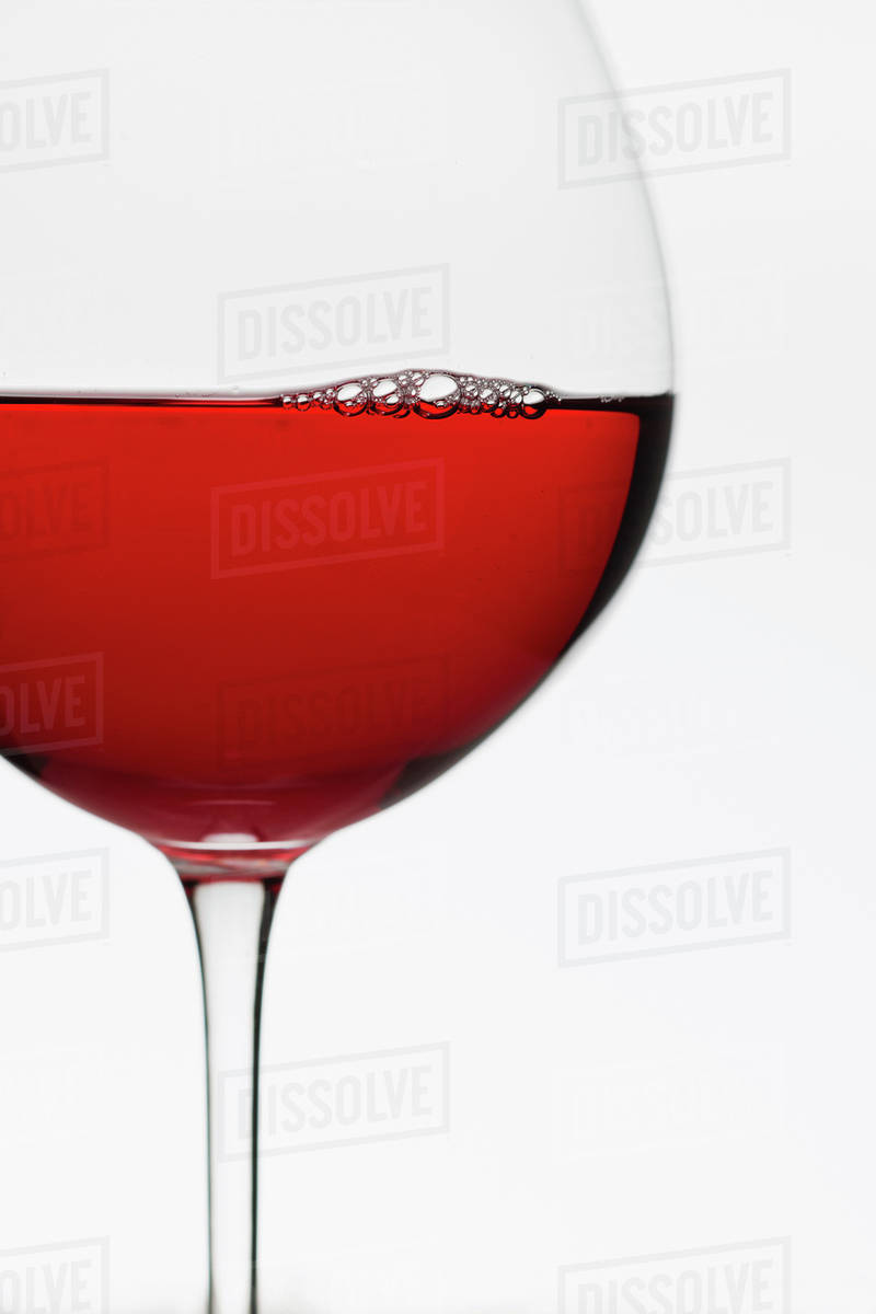 Close up of glass of red wine on white background - Stock Photo - Dissolve