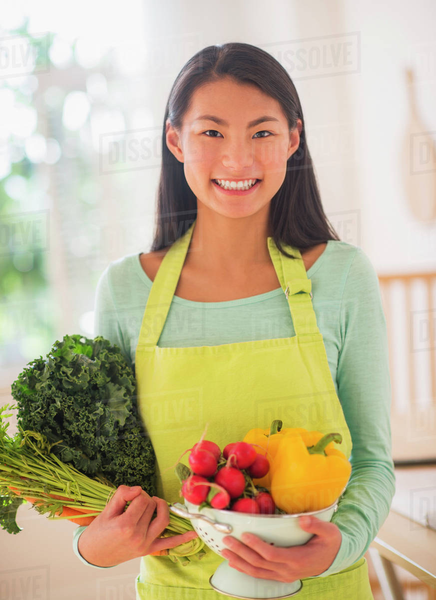 Teenage girl with bunch of vegetables in kitchen - Royalty-free Stock ...