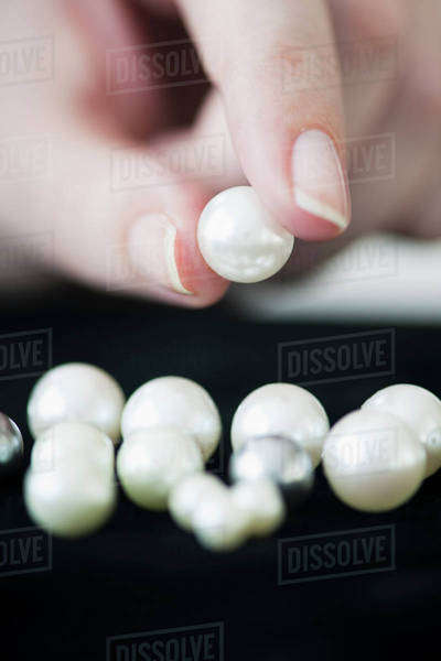 Woman holding pearl - Stock Photo - Dissolve